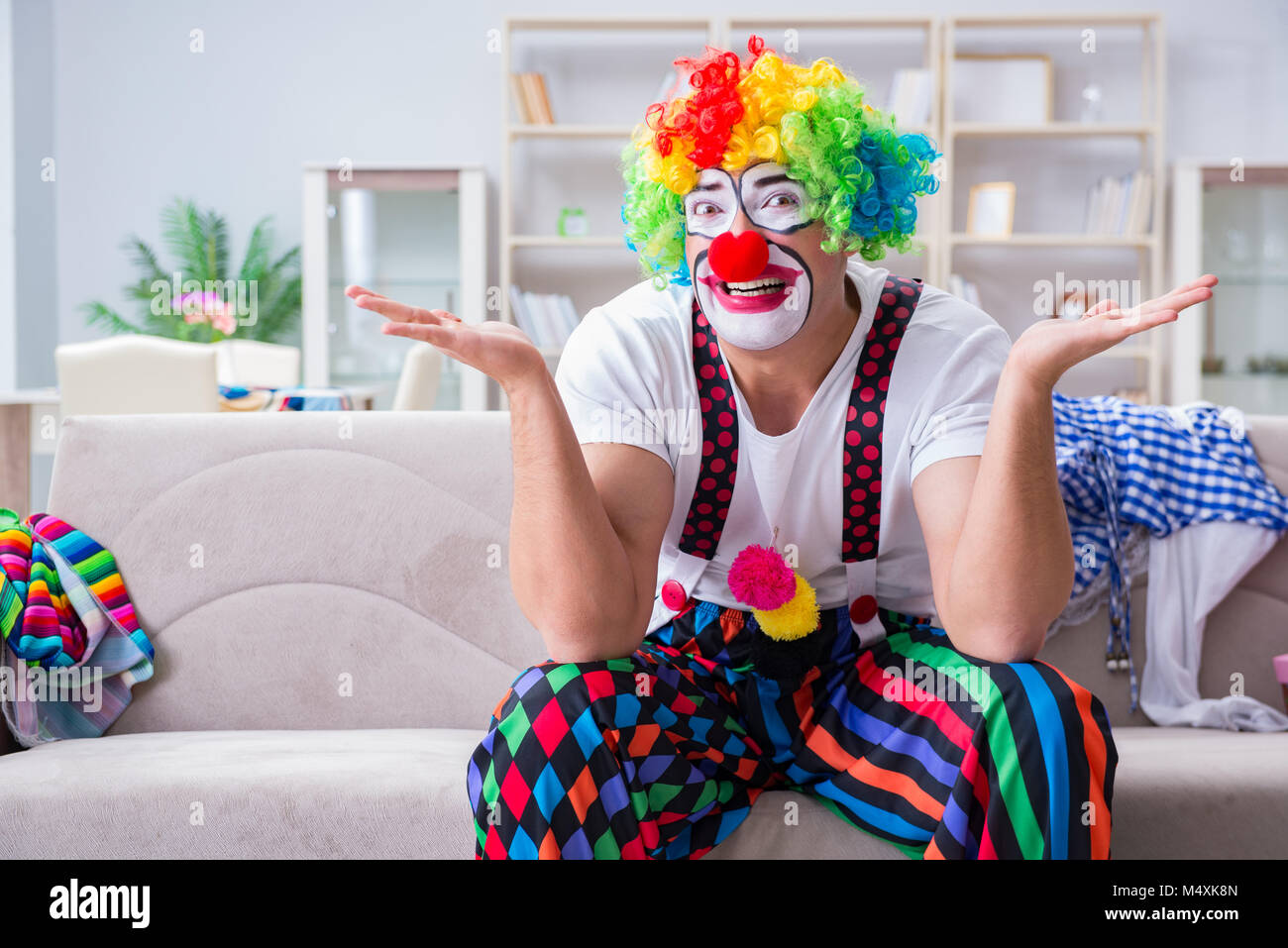 Drunk clown celebrating having a party at home Stock Photo - Alamy