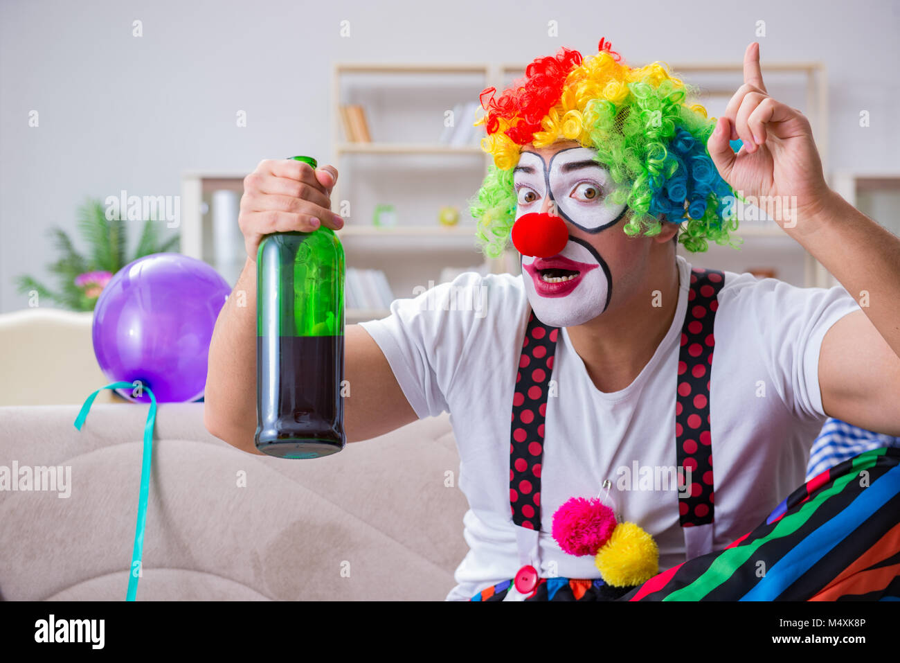 Drunk clown celebrating having a party at home Stock Photo - Alamy