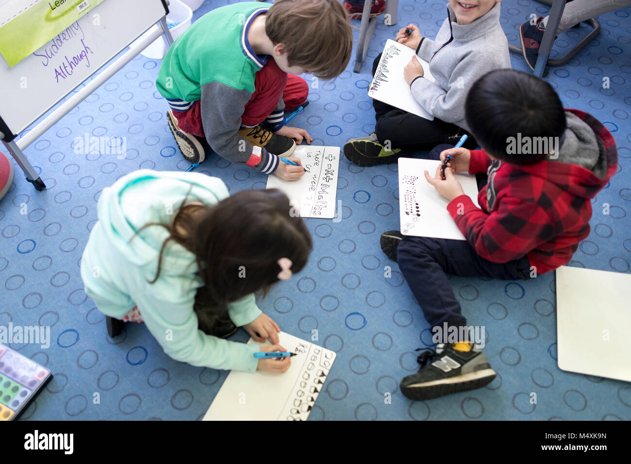 primary school children working in classroom Stock Photo - Alamy
