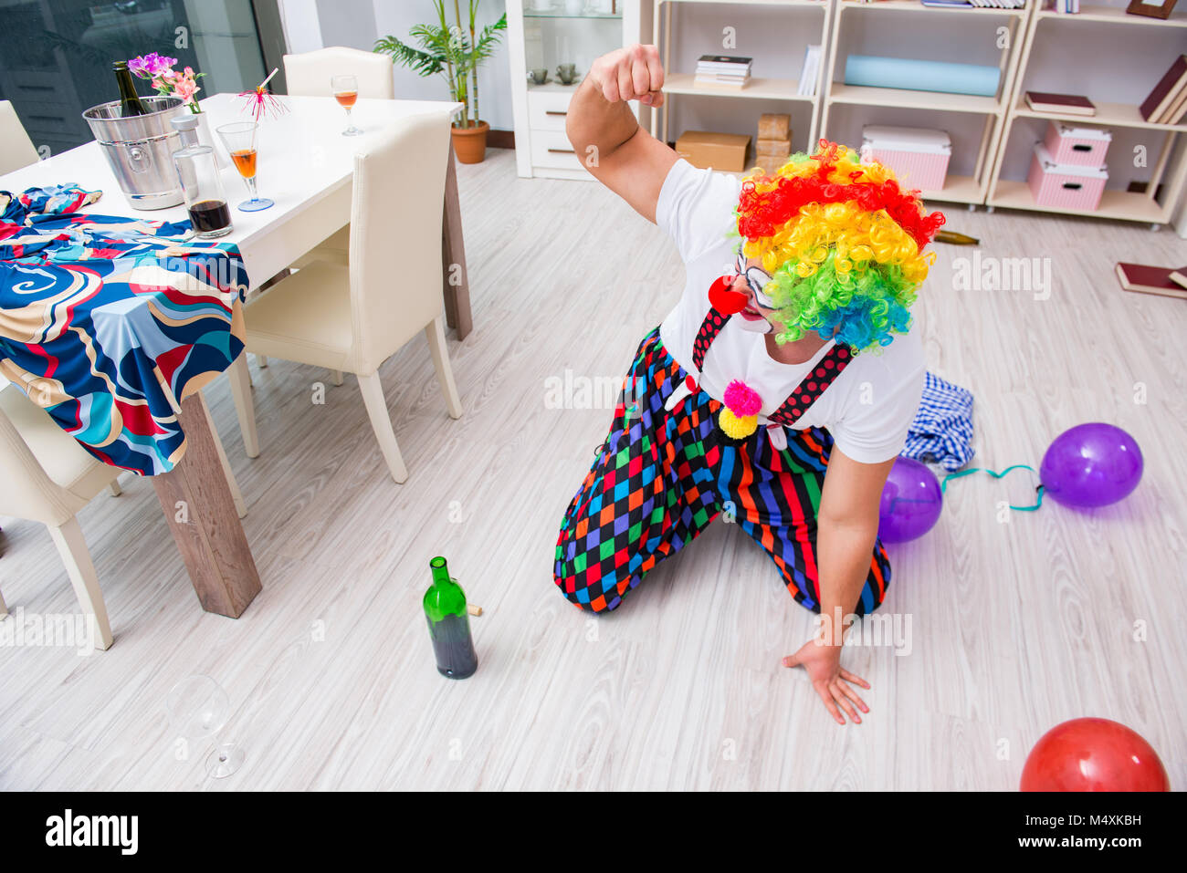 Drunk clown celebrating having a party at home Stock Photo - Alamy