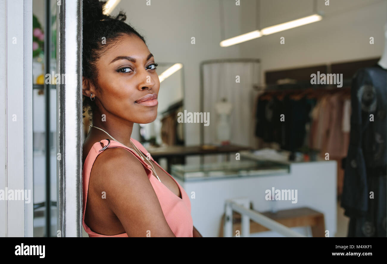 Female fashion designer standing in her boutique. Female dress designer ...