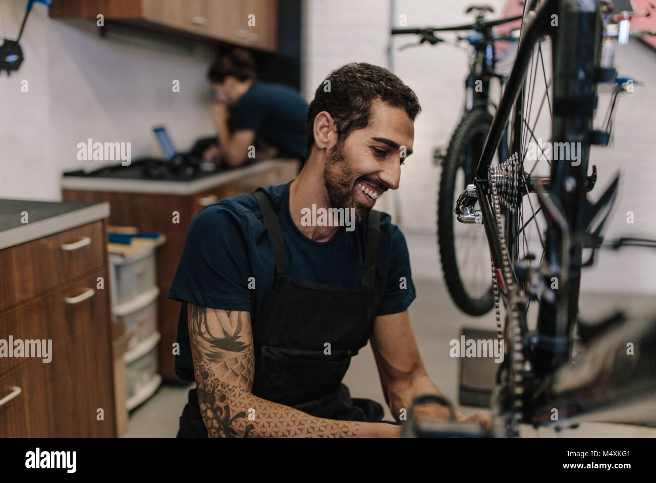 Fixing his bike hi-res stock photography and images - Alamy