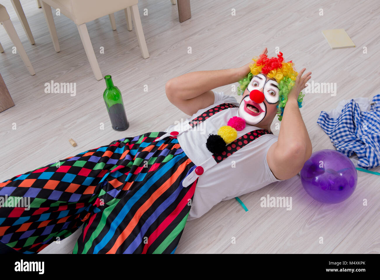 Drunk clown celebrating having a party at home Stock Photo - Alamy