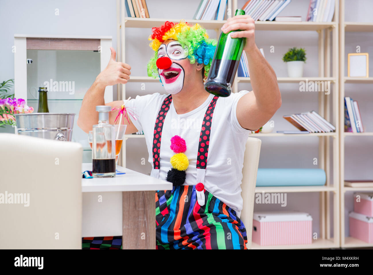 Drunk clown celebrating having a party at home Stock Photo - Alamy