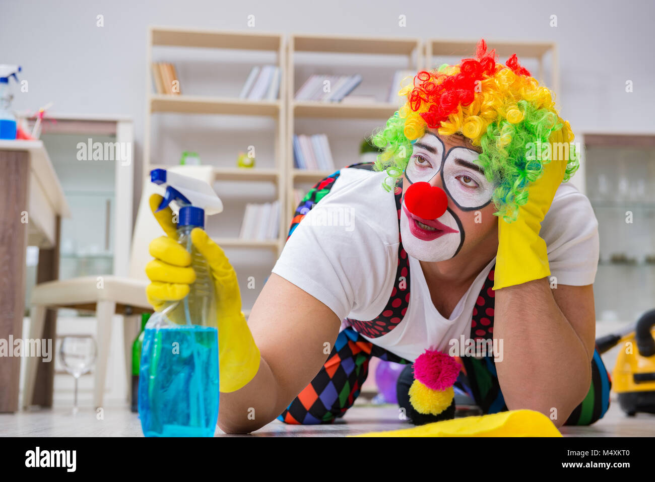 Funny clown doing cleaning at home Stock Photo - Alamy