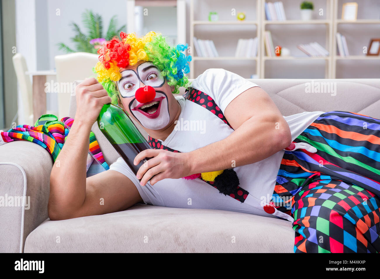 Drunk clown celebrating having a party at home Stock Photo - Alamy
