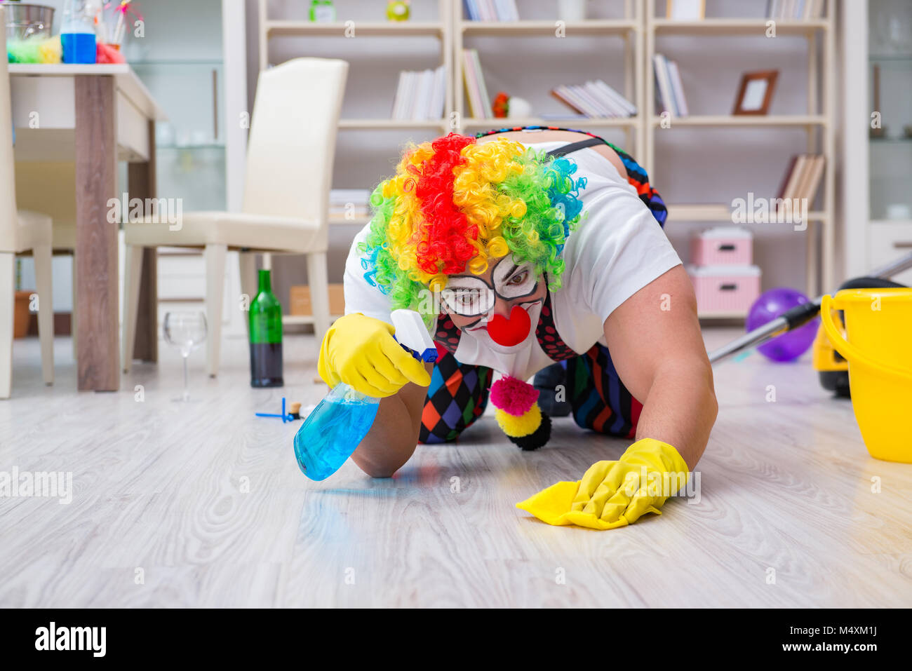 Funny clown doing cleaning at home Stock Photo - Alamy
