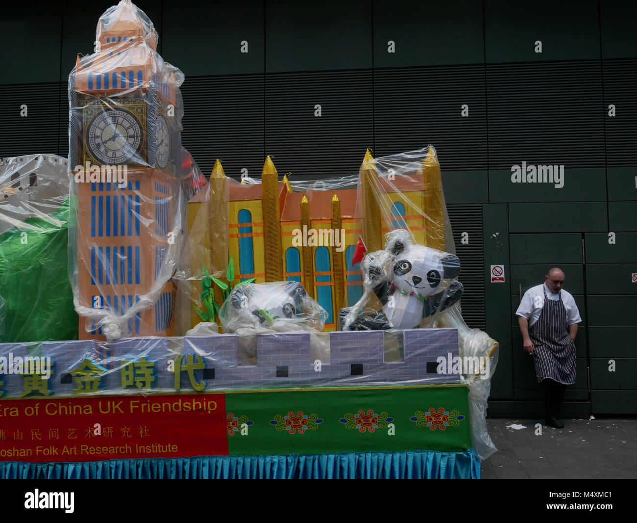Procession float and chef taking a break in London's Chinatown during ...