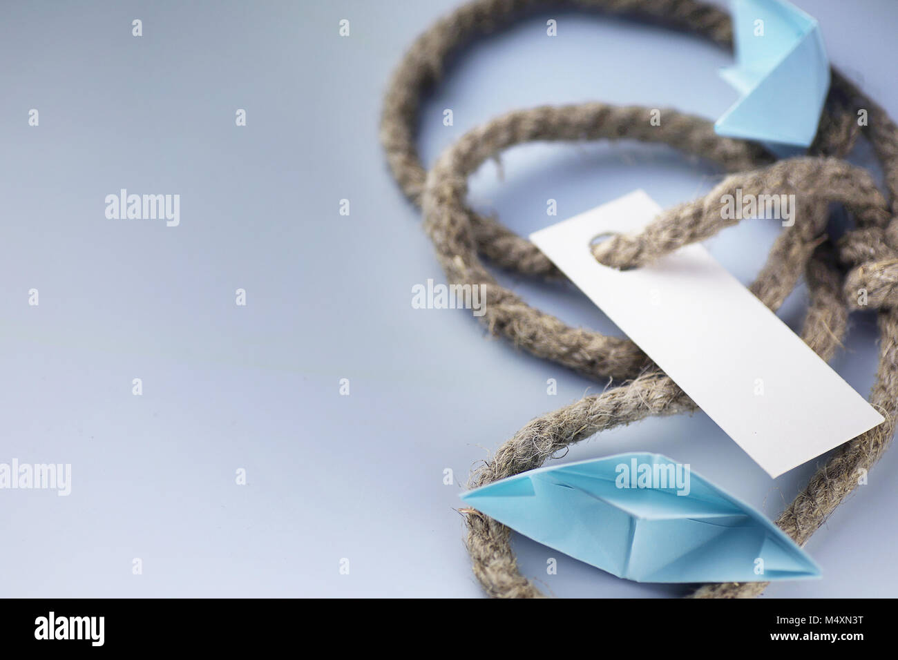 sticker with thick braided rope and ship paper origami Stock Photo - Alamy