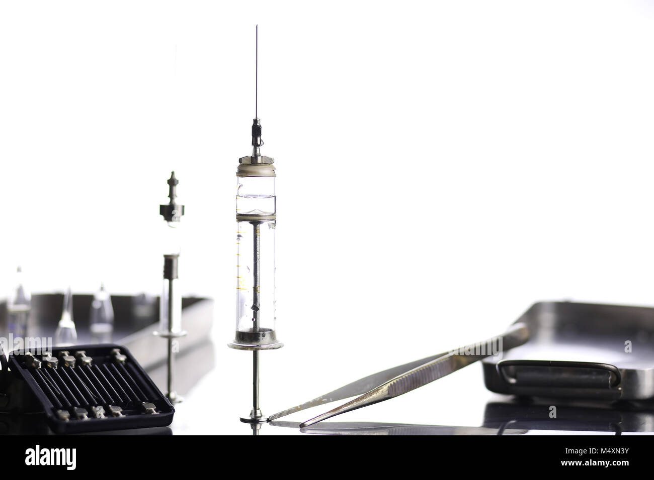 Old metal medical syringe and accessories on the table Stock Photo - Alamy