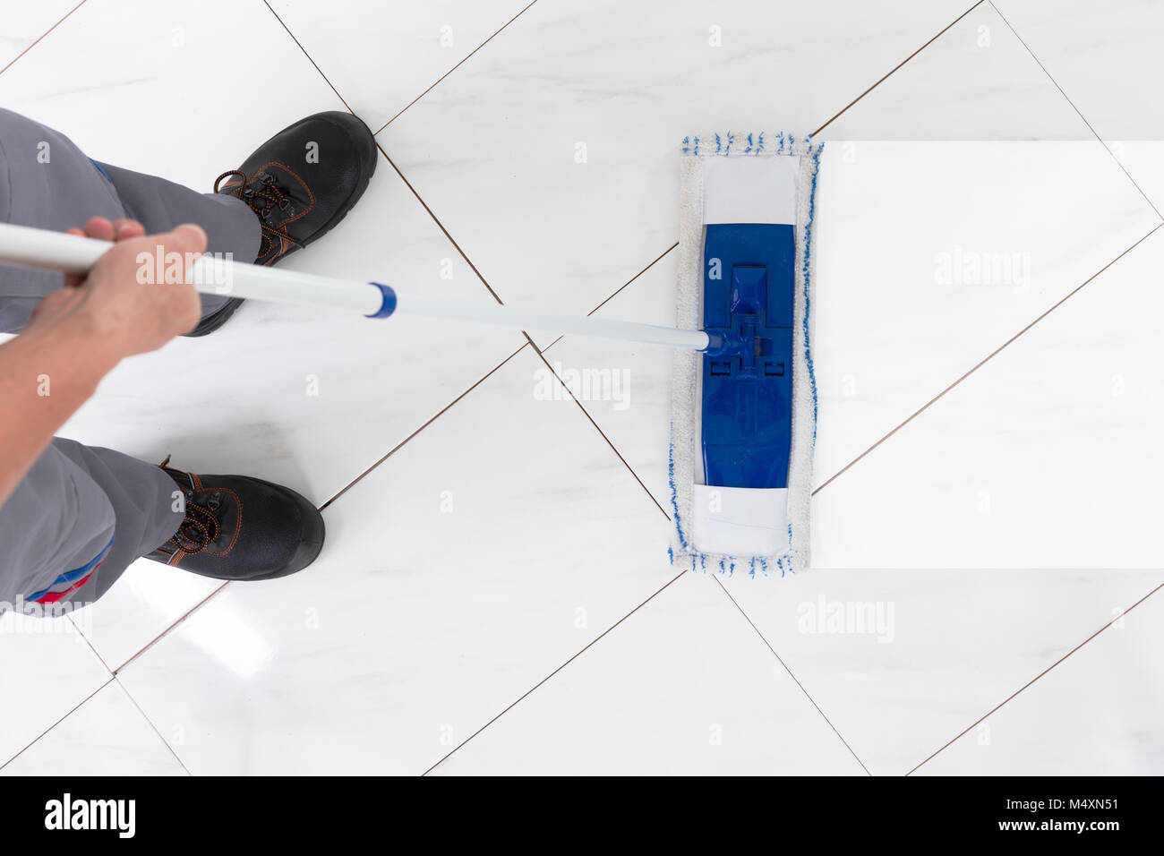 Worker Mopping Floor With Mop In Kitchen Stock Photo - Alamy