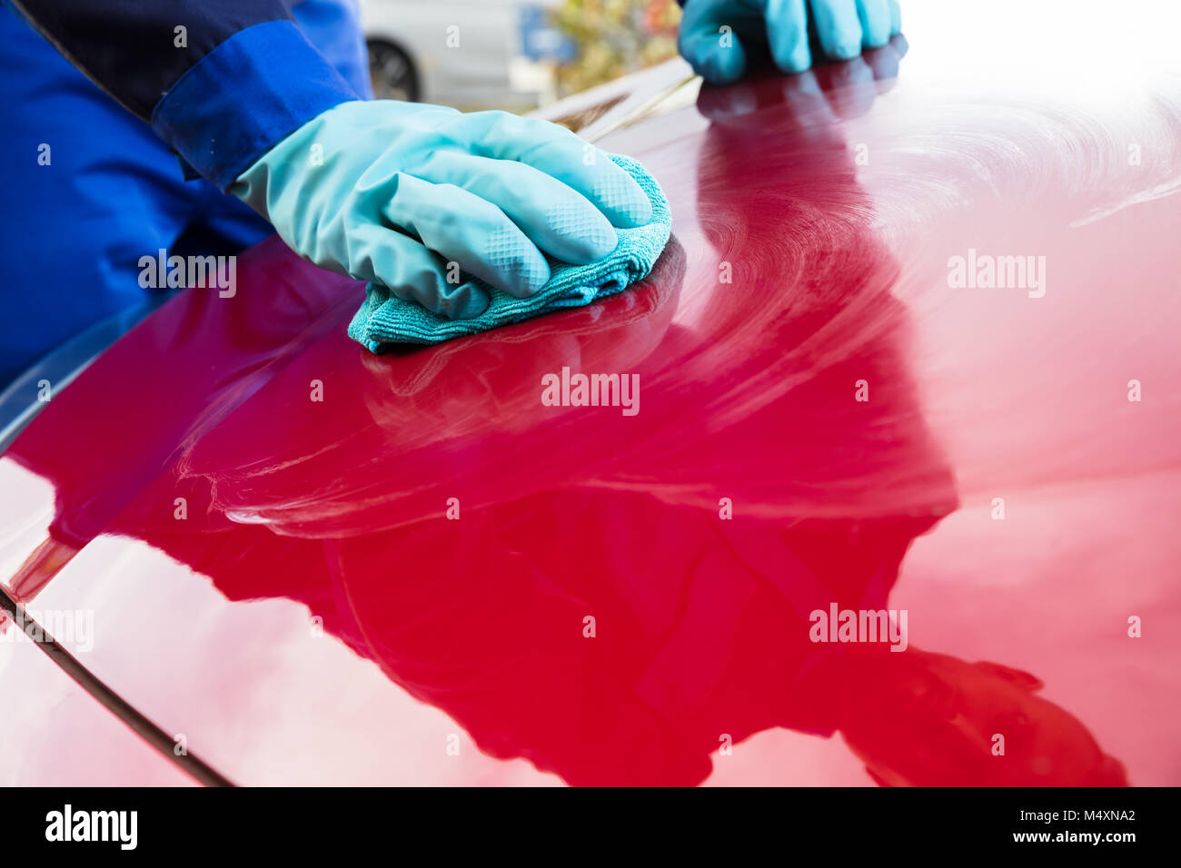 Young Happy Male Worker Cleaning Red Car With Cloth Stock Photo - Alamy