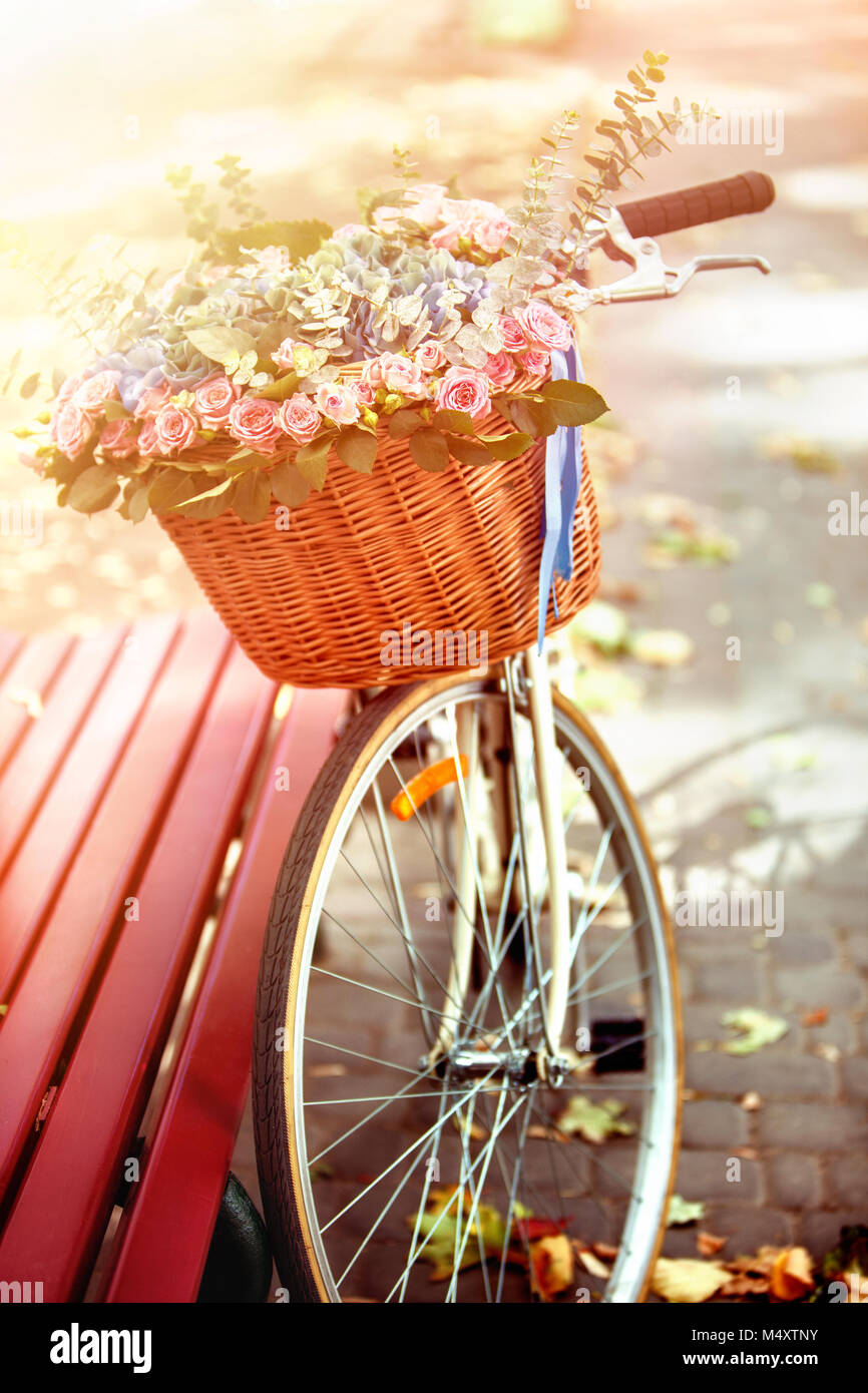 Bike with basket of spring flowers in Park Stock Photo - Alamy