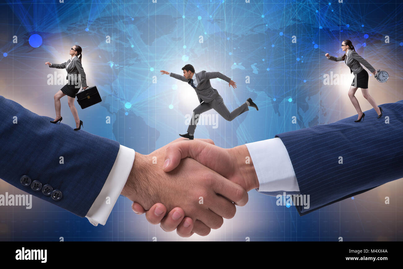 Cooperation concept with people running on handshake Stock Photo - Alamy