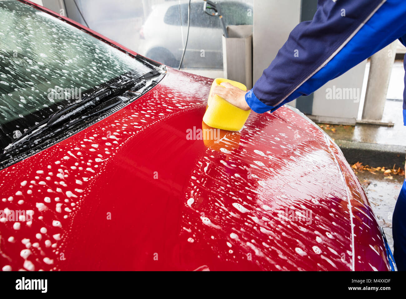 Close-up Of Worker's Hand Washing Red Car With Yellow Sponge At Service ...