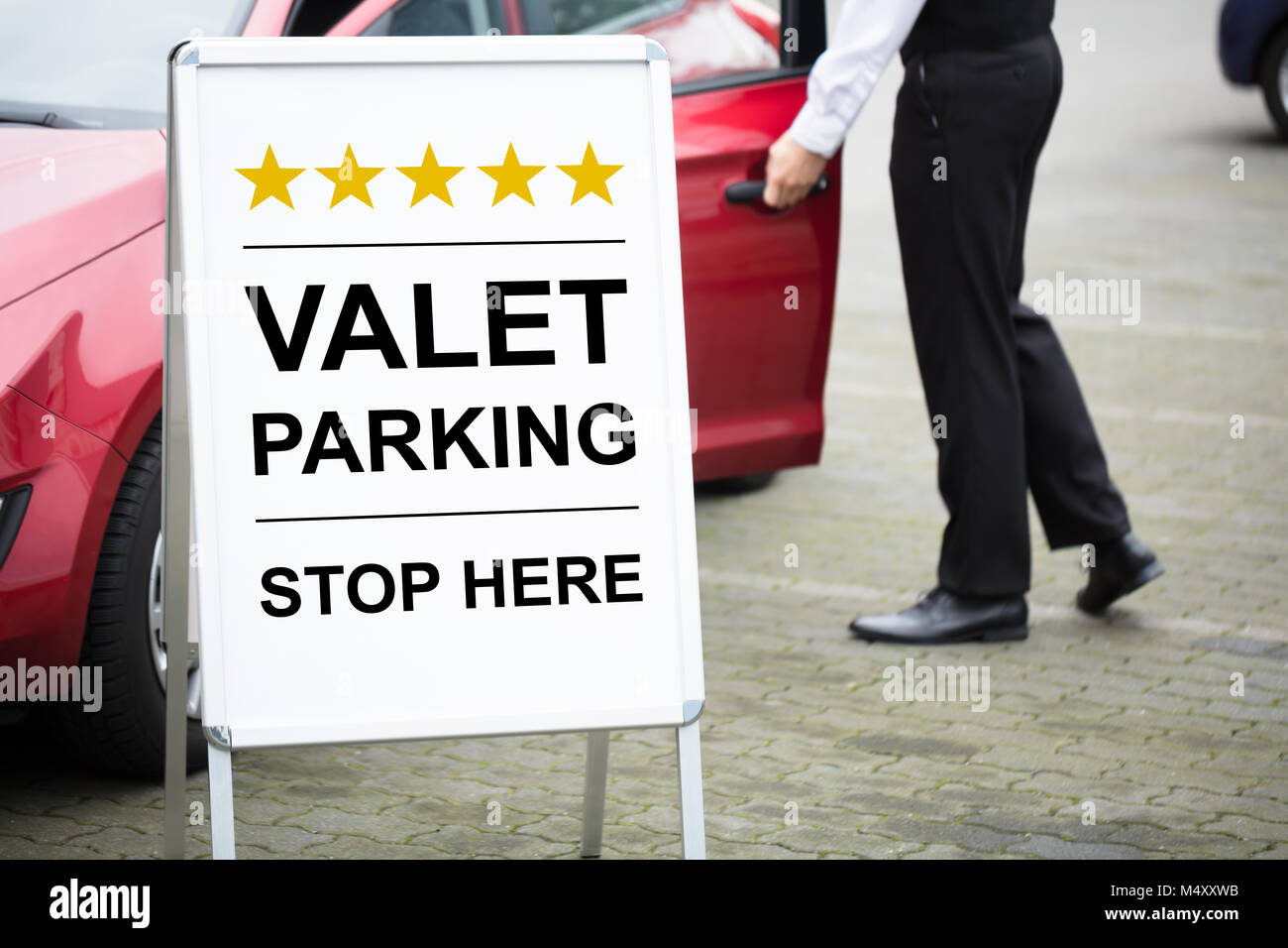 Close-up Of Male Valet Standing Near Valet Parking Sign Stock Photo - Alamy
