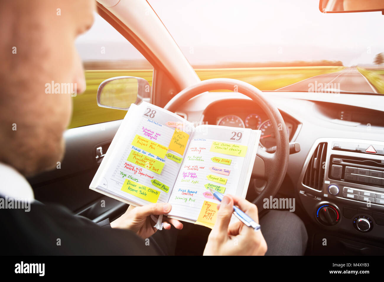 Close-up Of A Businessman Writing Schedule In Diary With Pen Inside ...