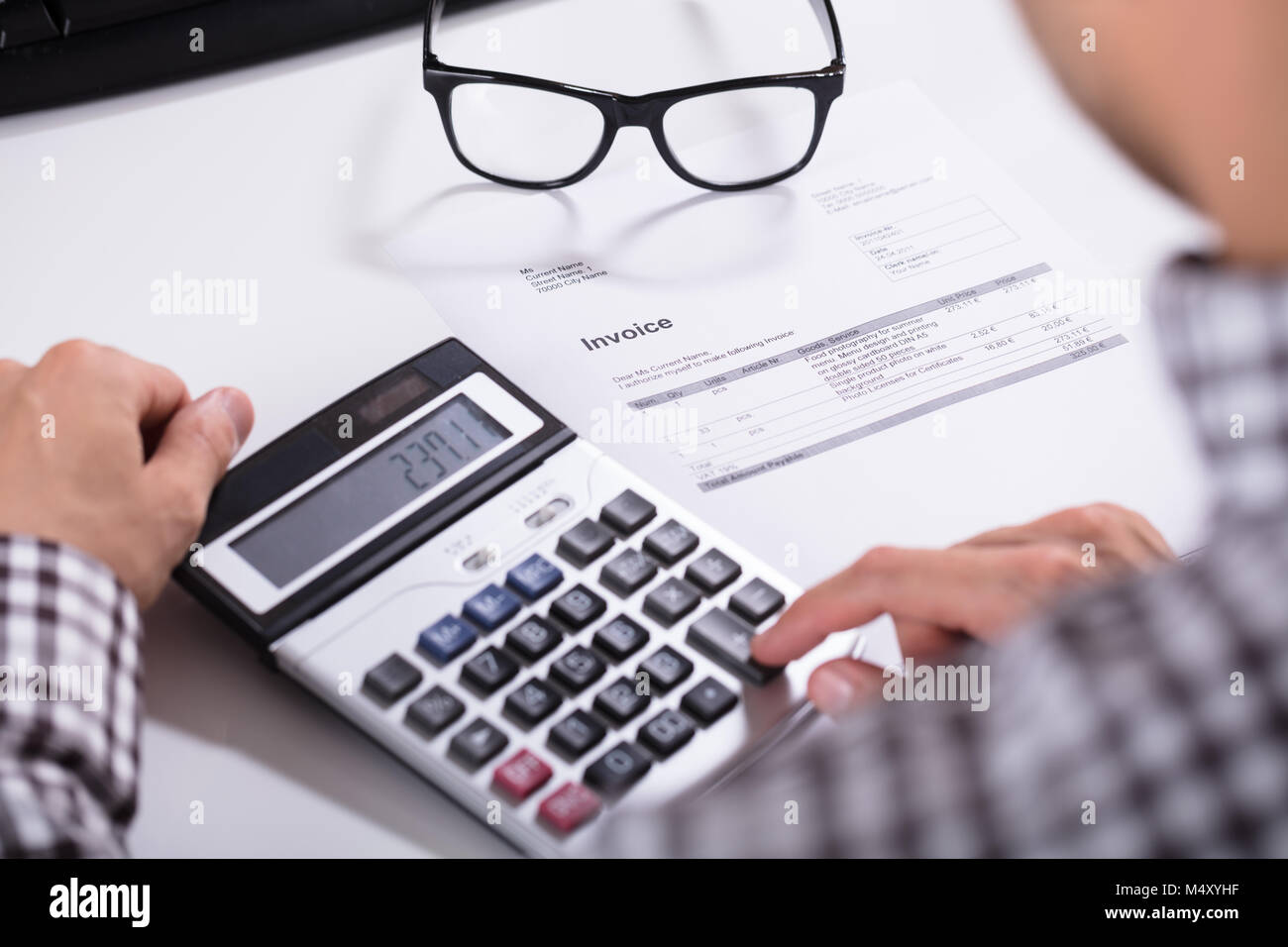 Close-up Of Businessman's Hands Calculating Invoice Using Calculator ...