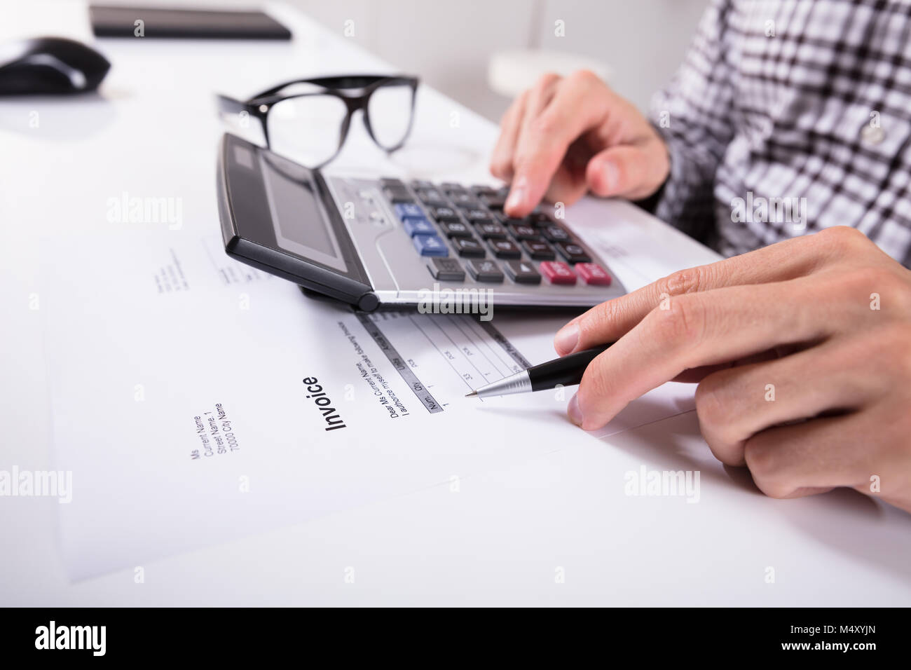 Close-up Of Businessman's Hands Calculating Invoice Using Calculator ...
