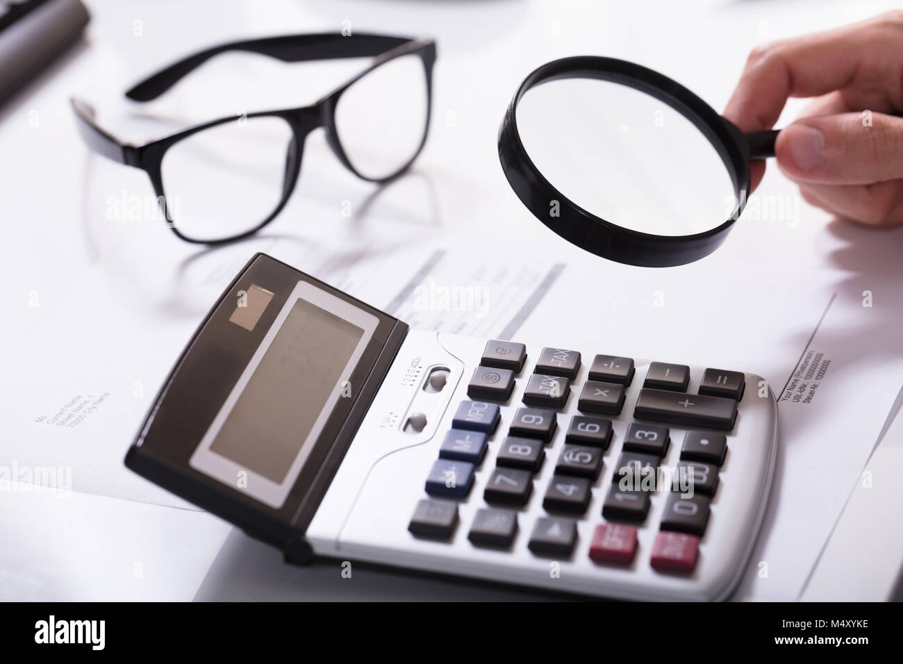 Elevated View Of Businessman Hand Examining Invoice With Magnifying ...