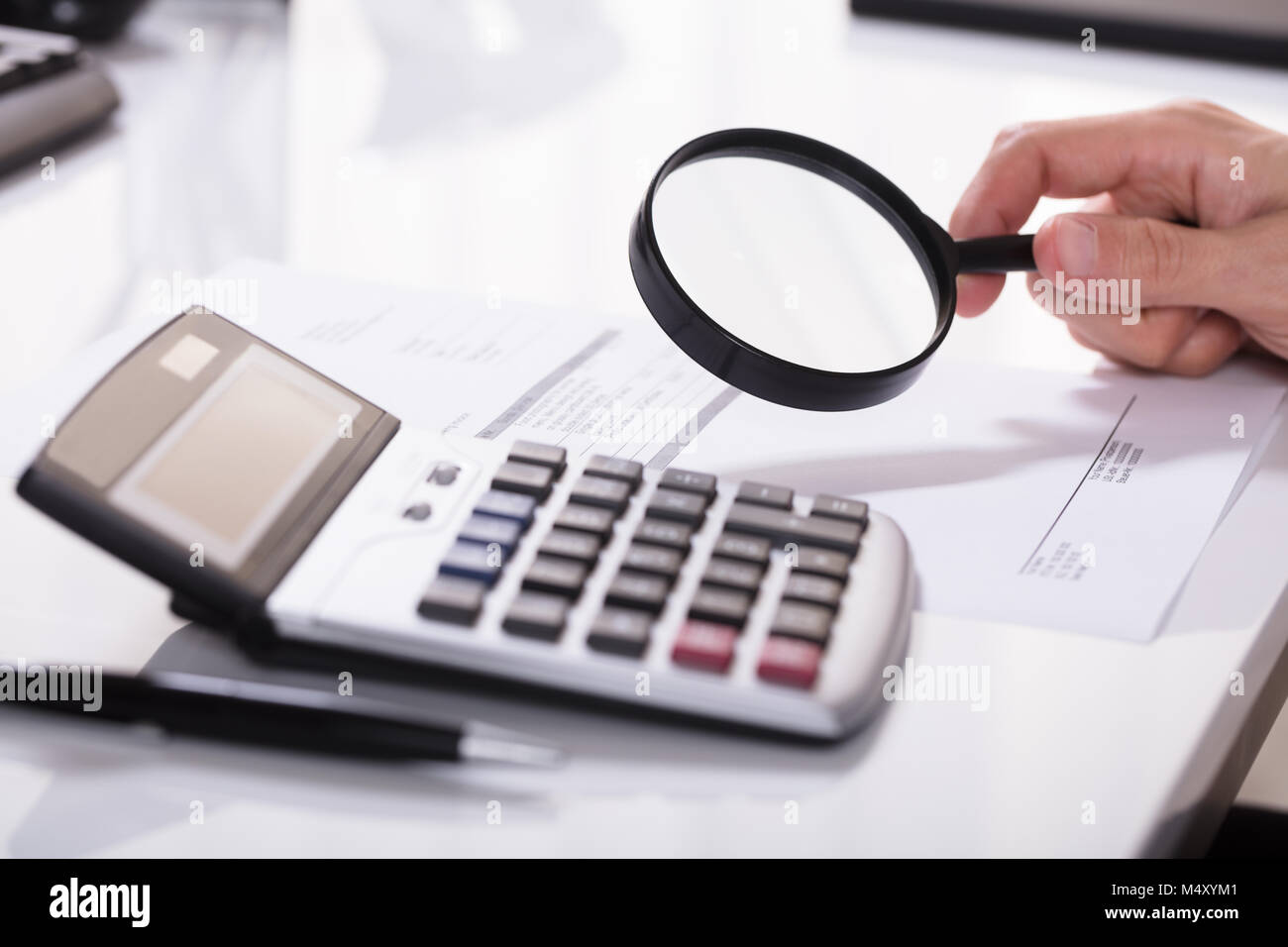 Elevated View Of Businessman Hand Examining Invoice With Magnifying ...
