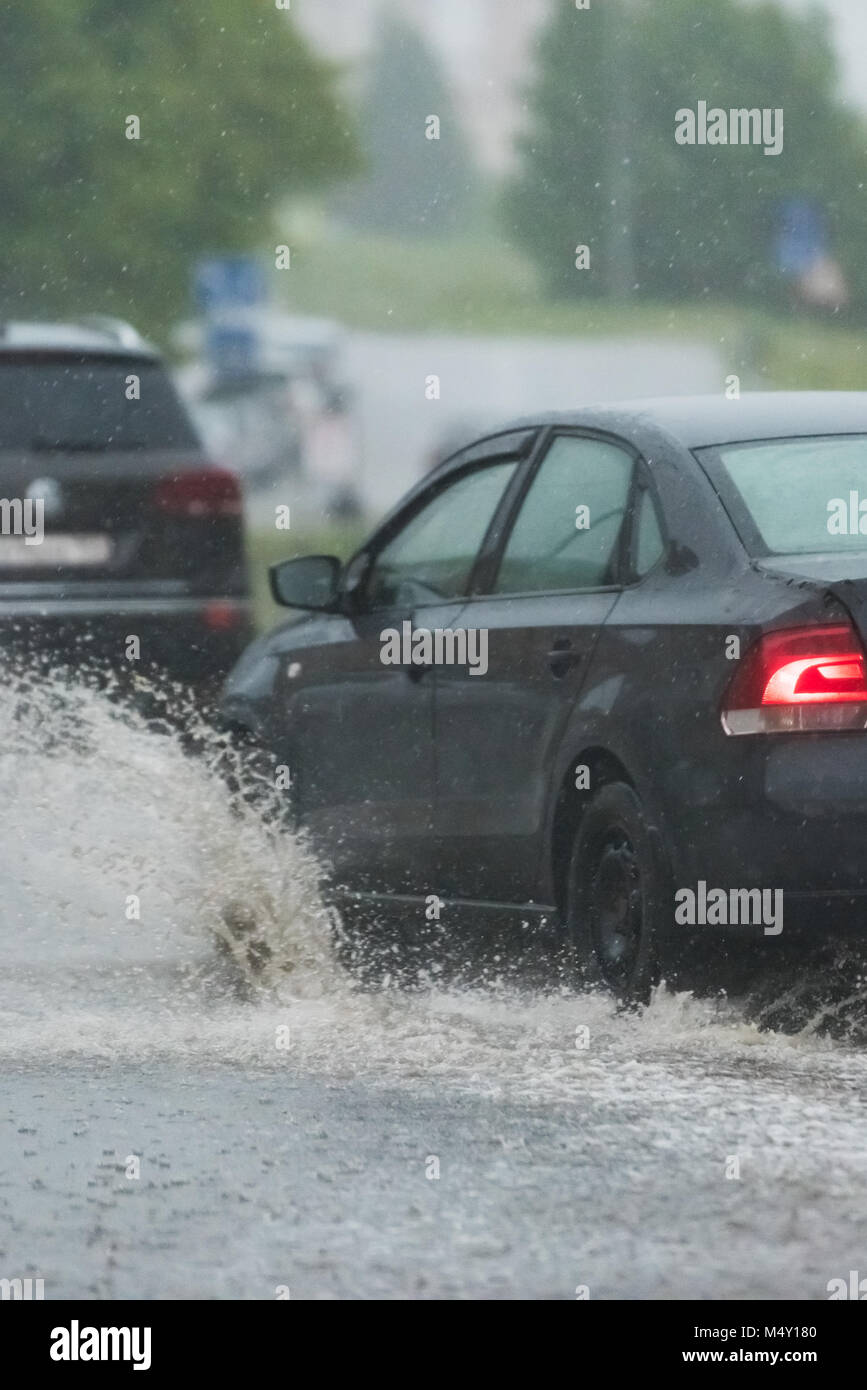 car rain puddle splashing water Stock Photo - Alamy