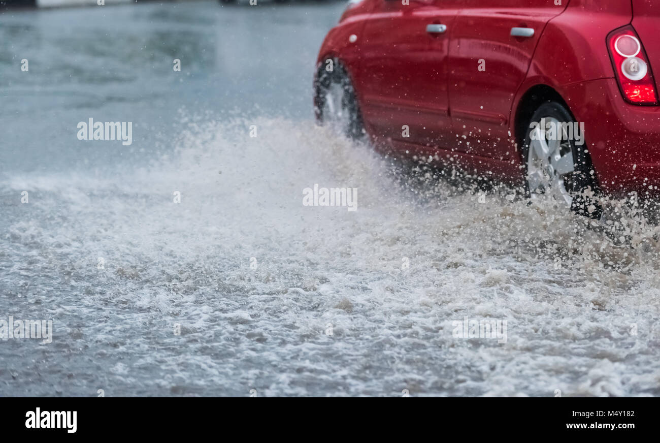 car rain puddle splashing water Stock Photo - Alamy