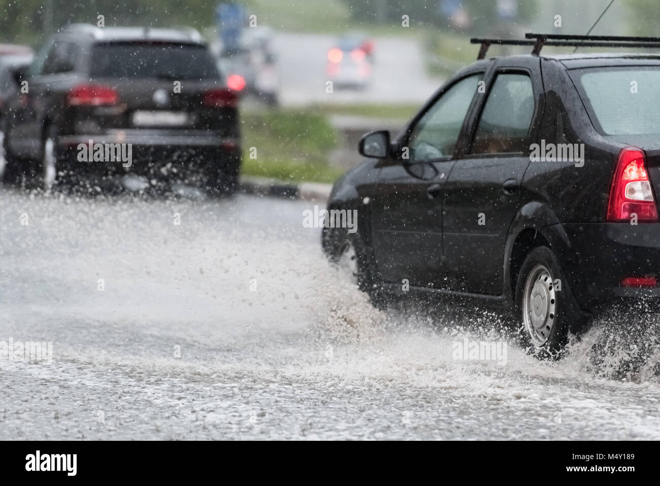 car rain puddle splashing water Stock Photo - Alamy