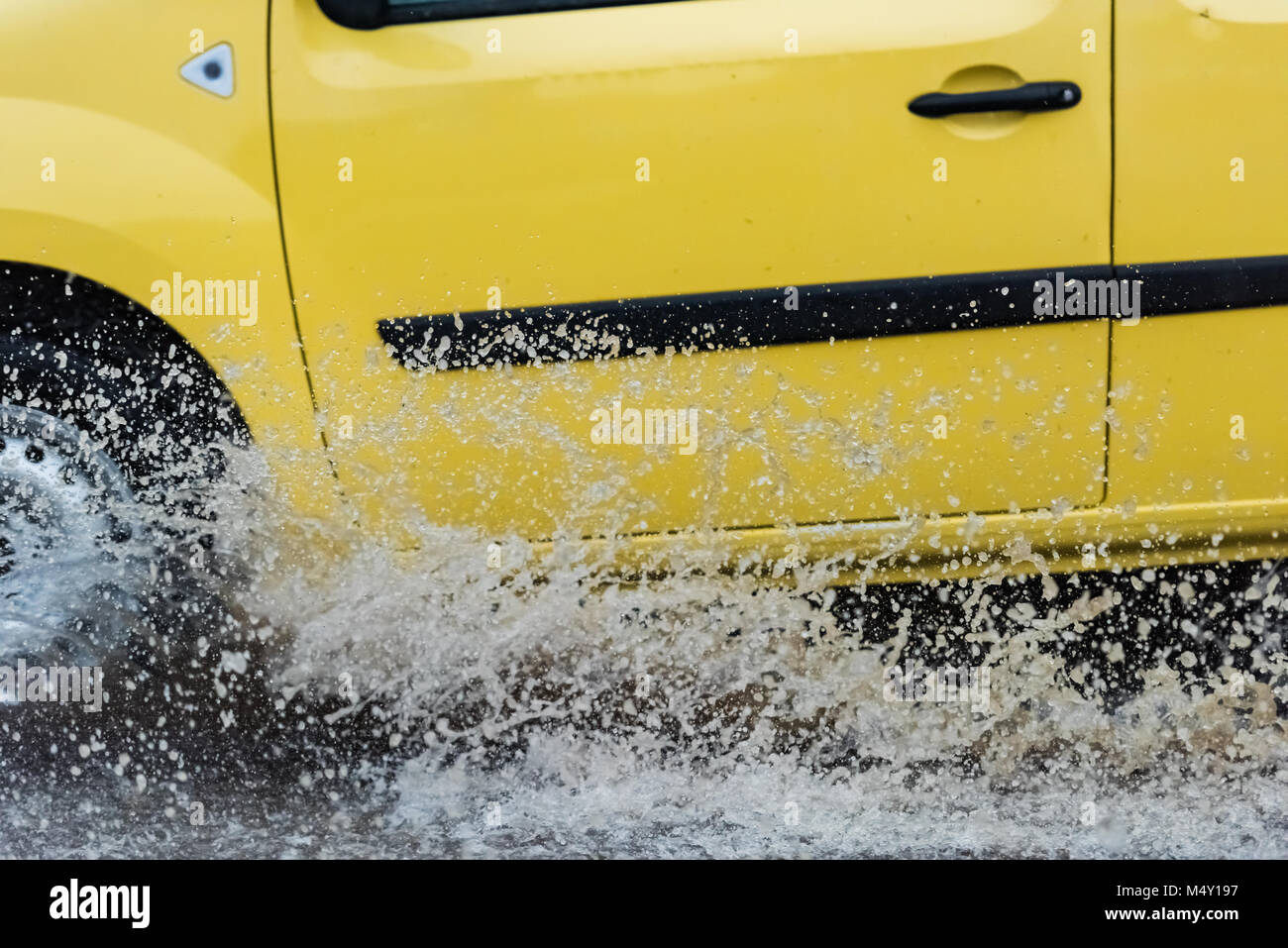 car rain puddle splashing water Stock Photo - Alamy
