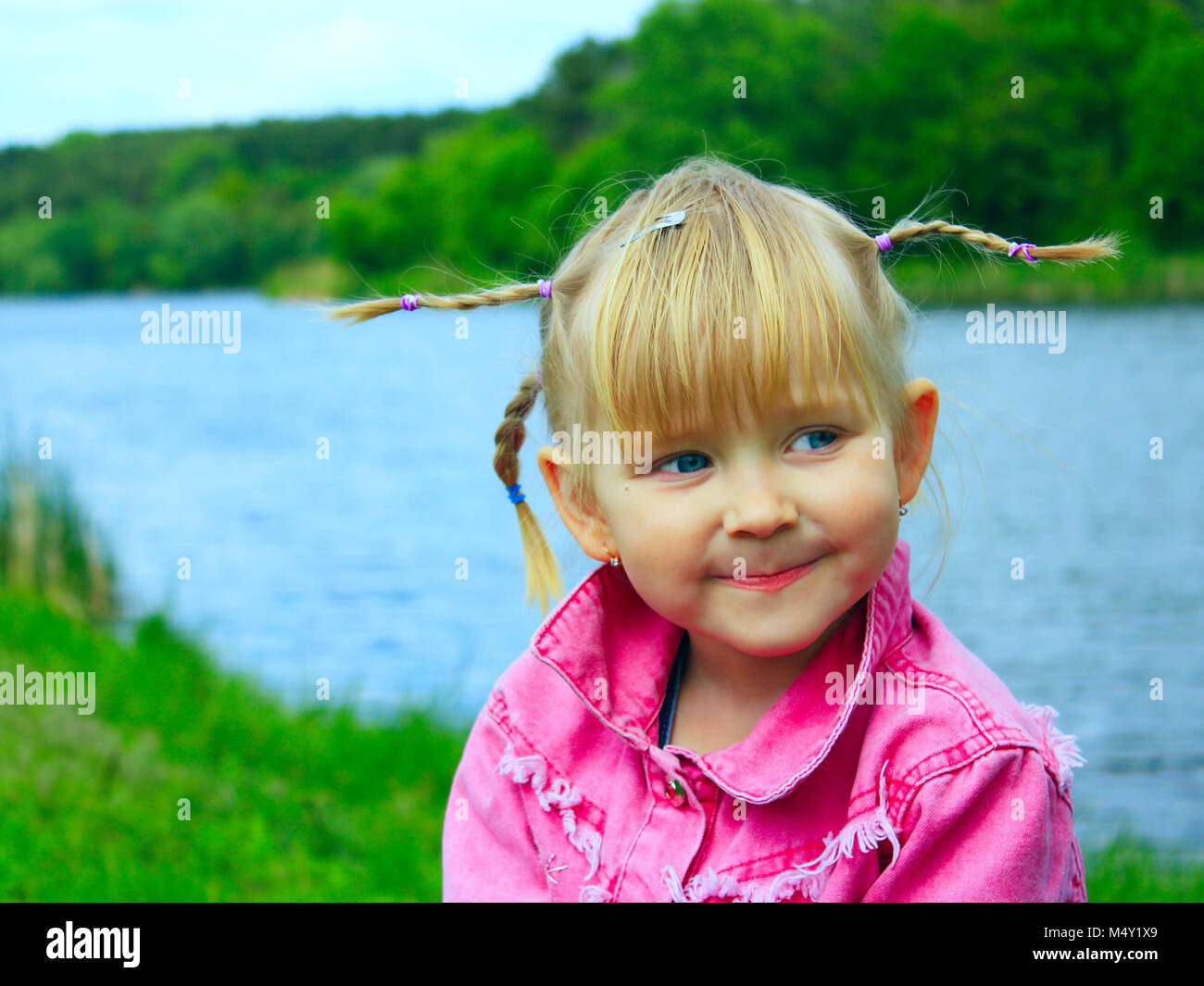 pretty smiling baby girl with nice plaits Stock Photo - Alamy