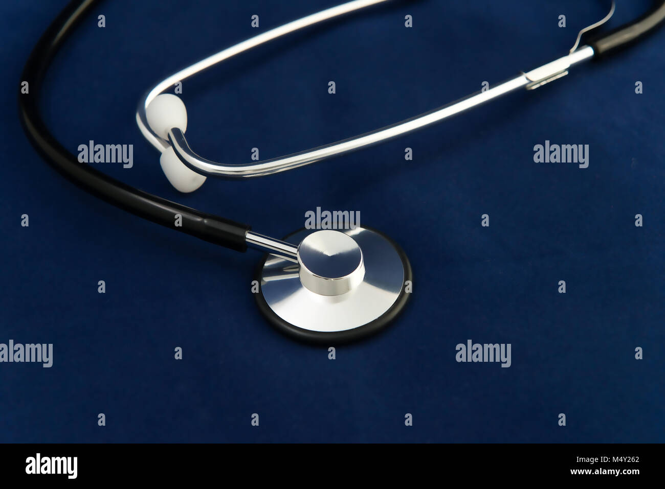 Stethoscope on dark blue background Stock Photo - Alamy