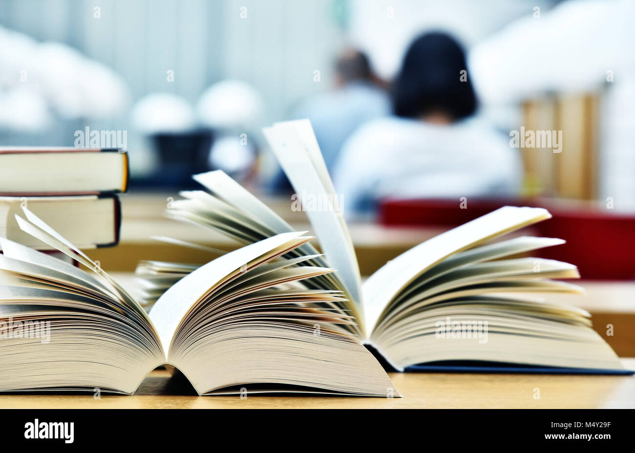 Books lying on the table in the public library Stock Photo - Alamy