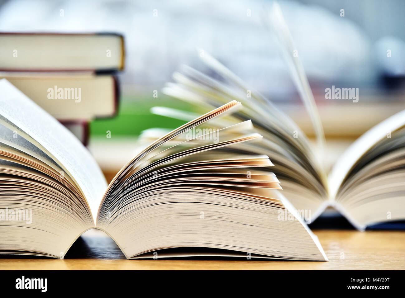 Books lying on the table in the public library Stock Photo - Alamy