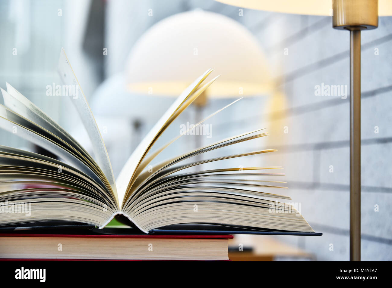 Books lying on the table in the public library Stock Photo - Alamy