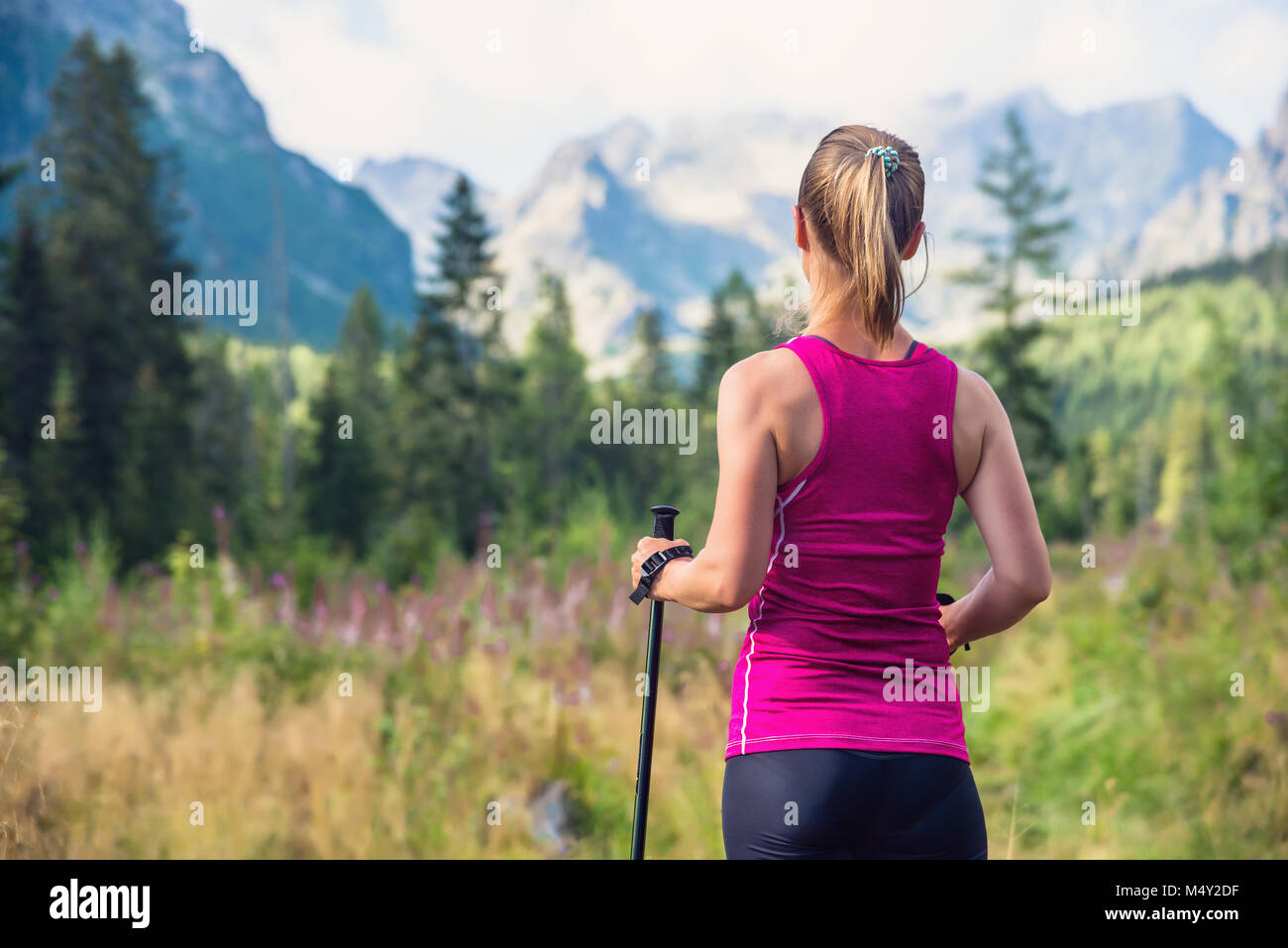 Young woman hiking in the mountains Stock Photo - Alamy