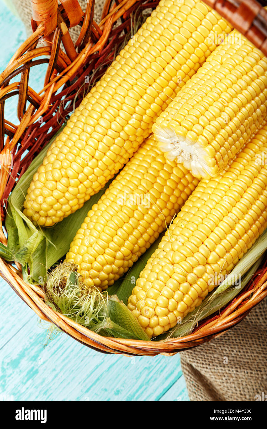 Basket of fresh sweetcorn, husked Stock Photo - Alamy