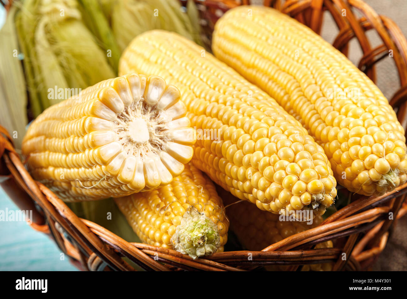 Basket of fresh sweetcorn, husked Stock Photo - Alamy