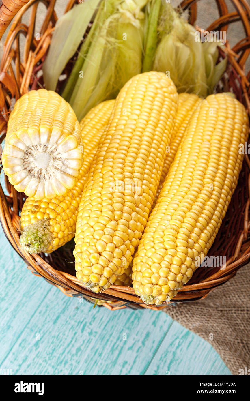 Basket of fresh sweetcorn, husked Stock Photo - Alamy
