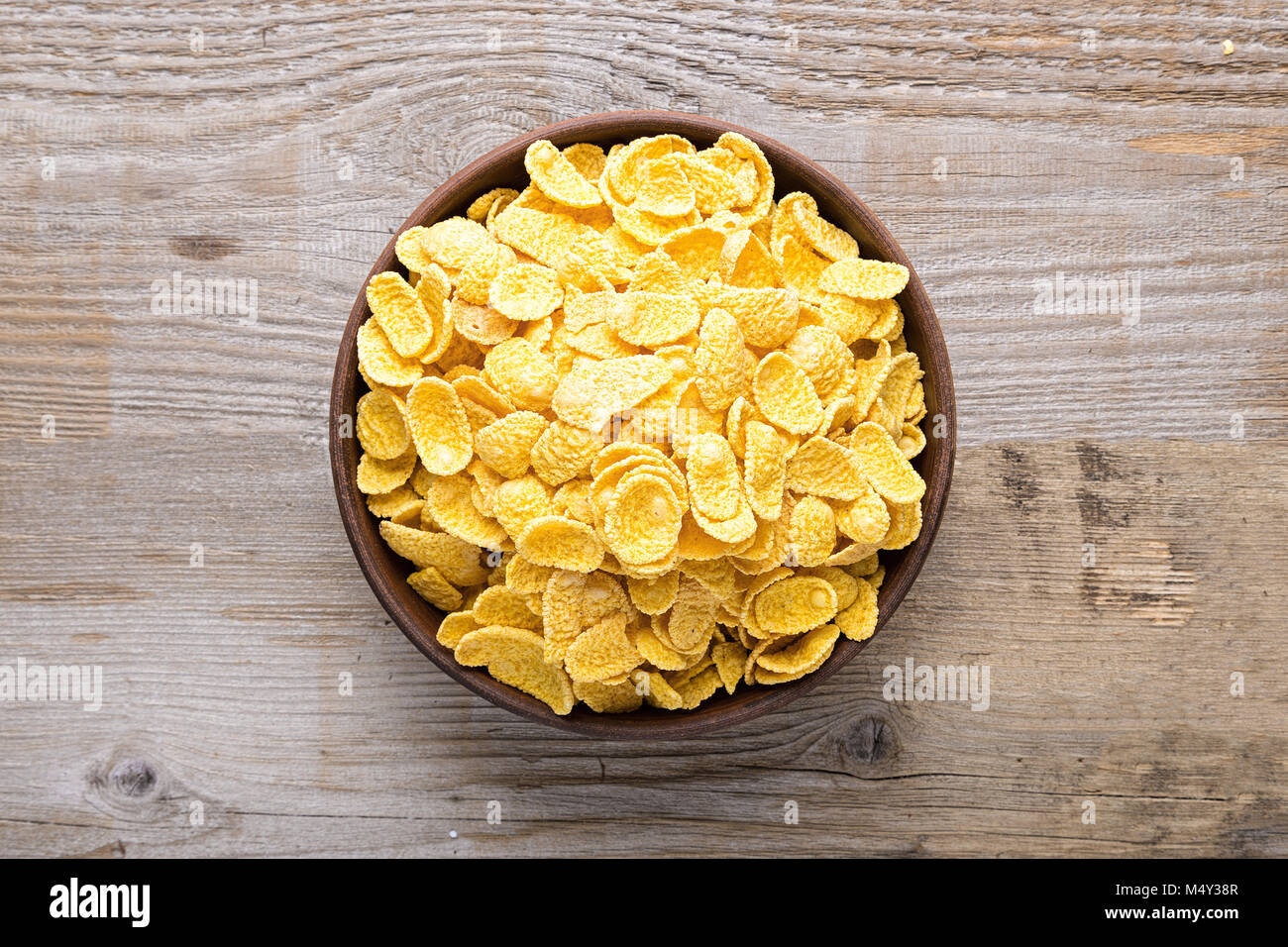 Cornflakes cereal in a clay bowl. Morning breakfast Stock Photo - Alamy