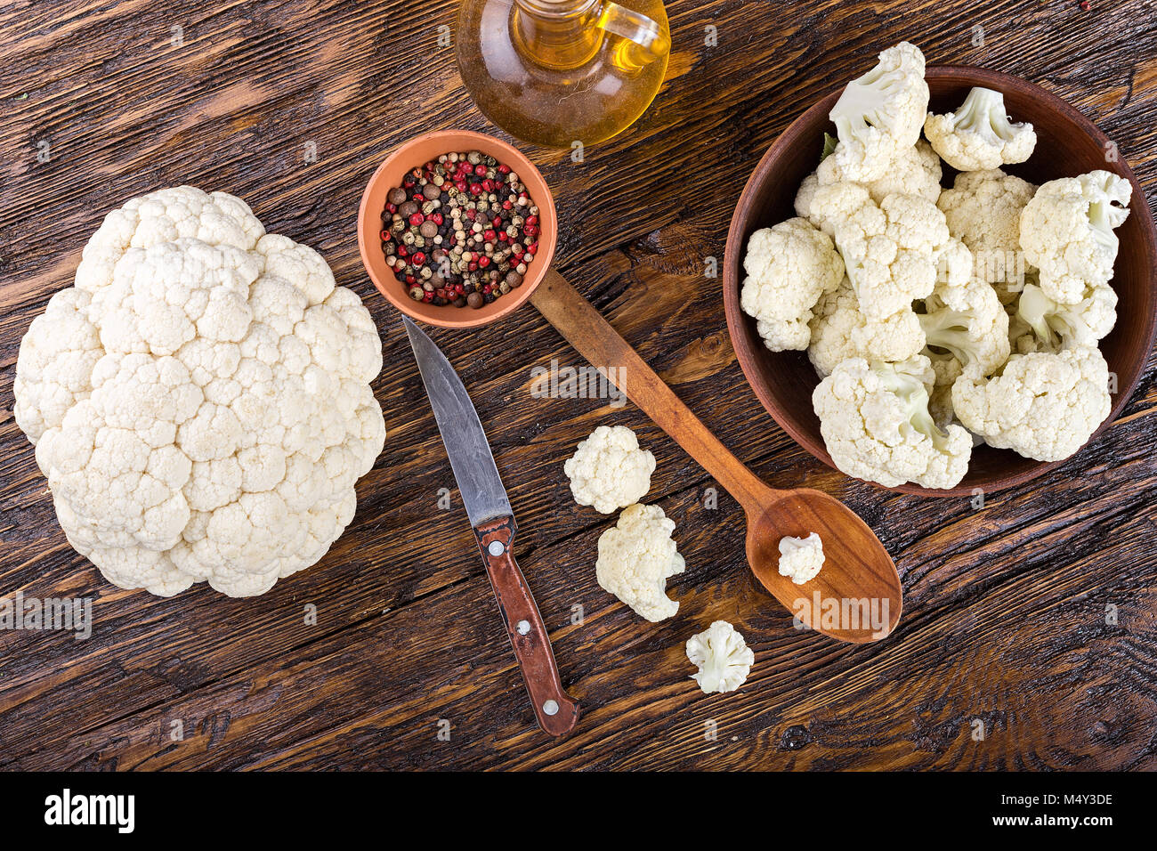 Useful cauliflower in a clay plate on a wooden table in the kitchen ...