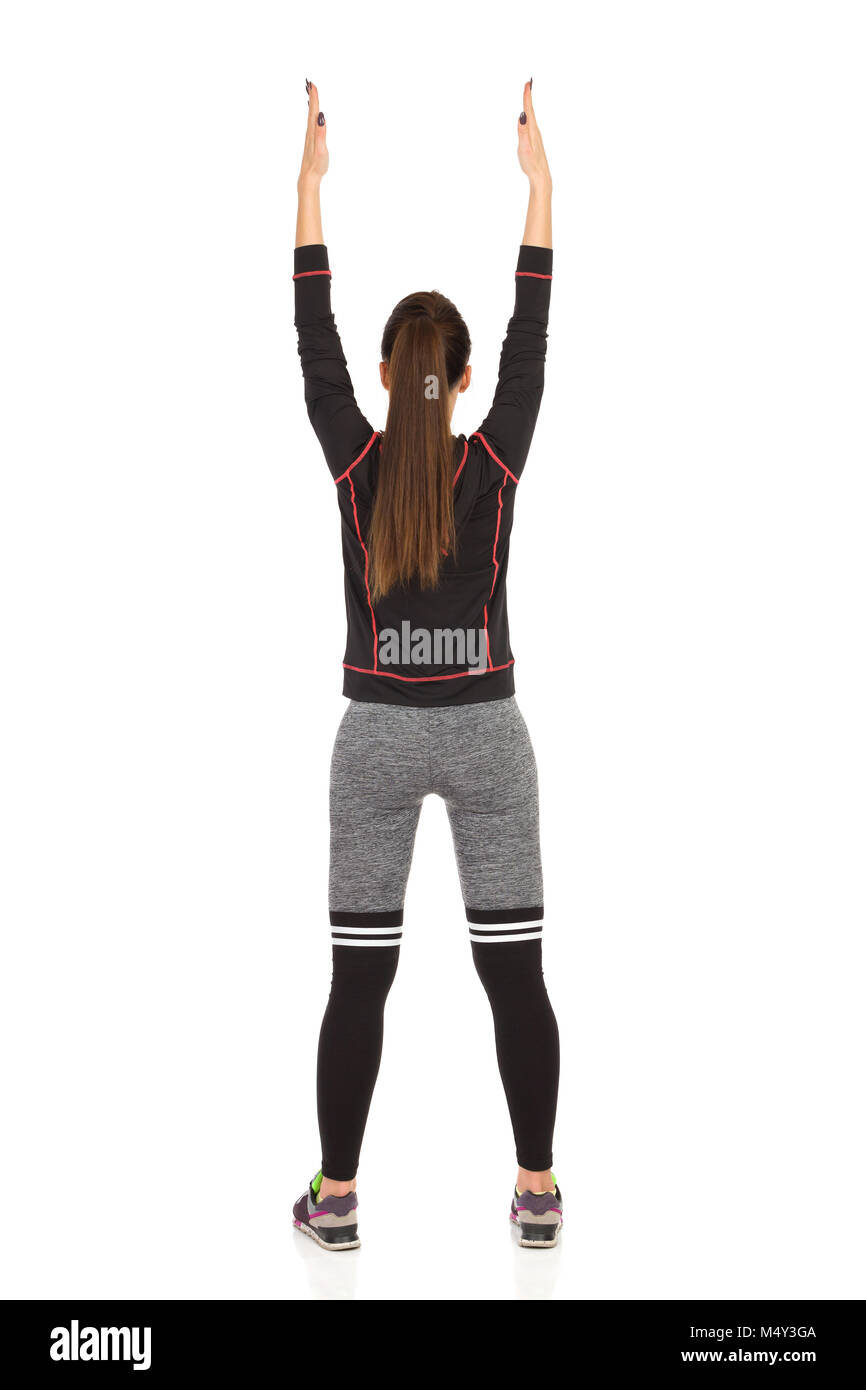 Woman arms raised rear view Cut Out Stock Images & Pictures - Alamy