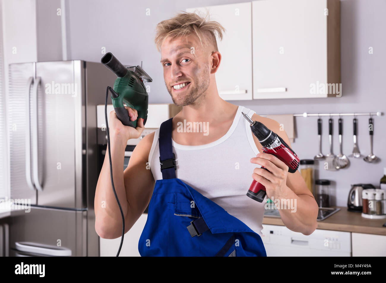 Funny workman holding a drill hi-res stock photography and images - Alamy