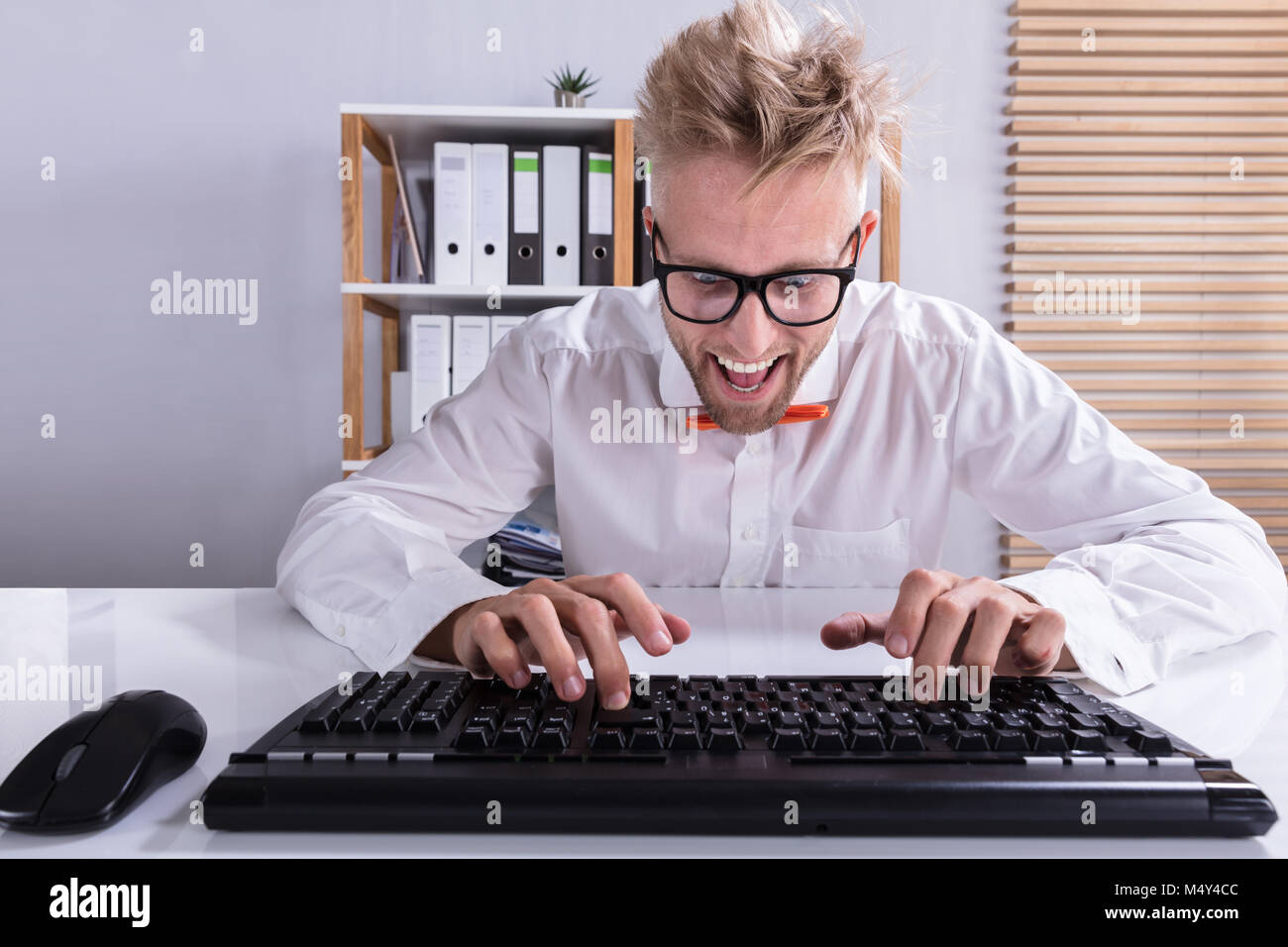 Nerd typing on keyboard hi-res stock photography and images - Alamy