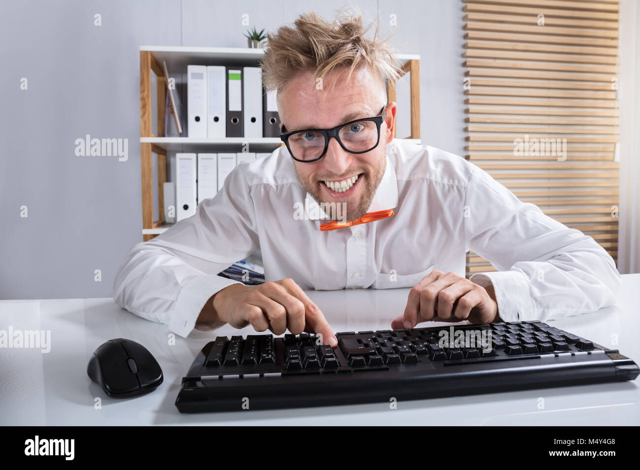 Nerd typing on keyboard hi-res stock photography and images - Alamy