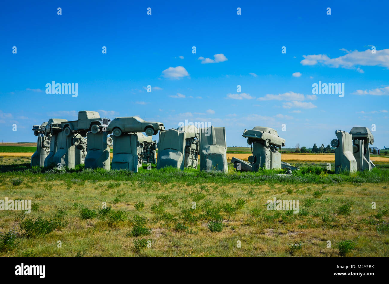 Outdoor sculpture of painted gray cars, arranged to look like ...