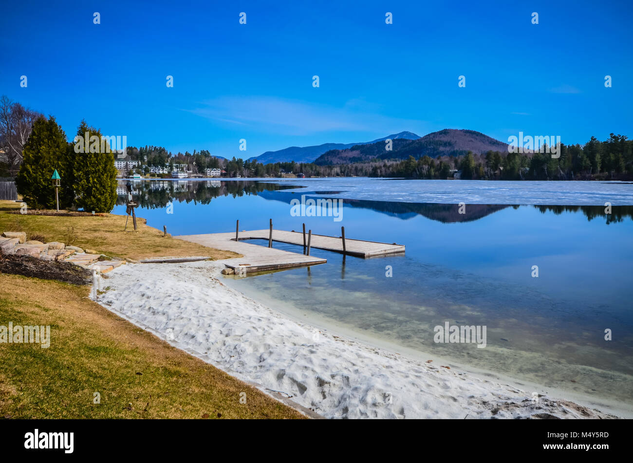 Empty beach and dock on Mirror Lake in Lake Placid, NY Stock Photo - Alamy
