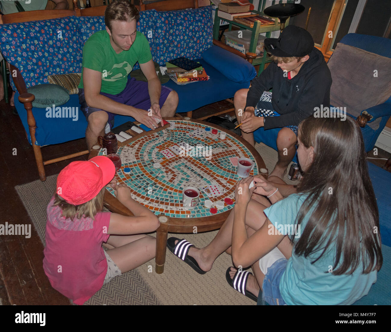 Teenage cousins playing poker at summer cabin retreat. Clitherall ...