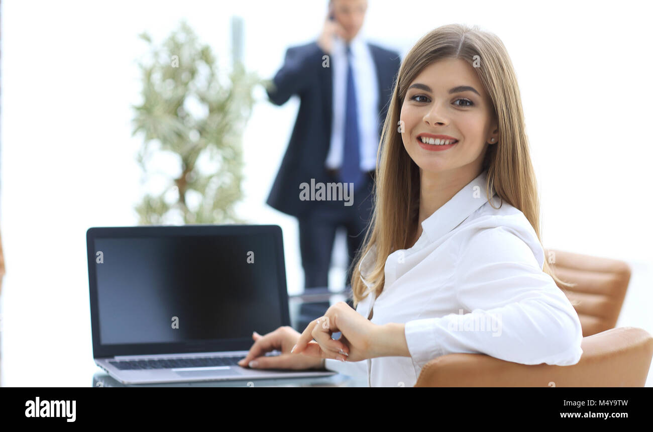 rear view.female assistant looking at the camera Stock Photo - Alamy