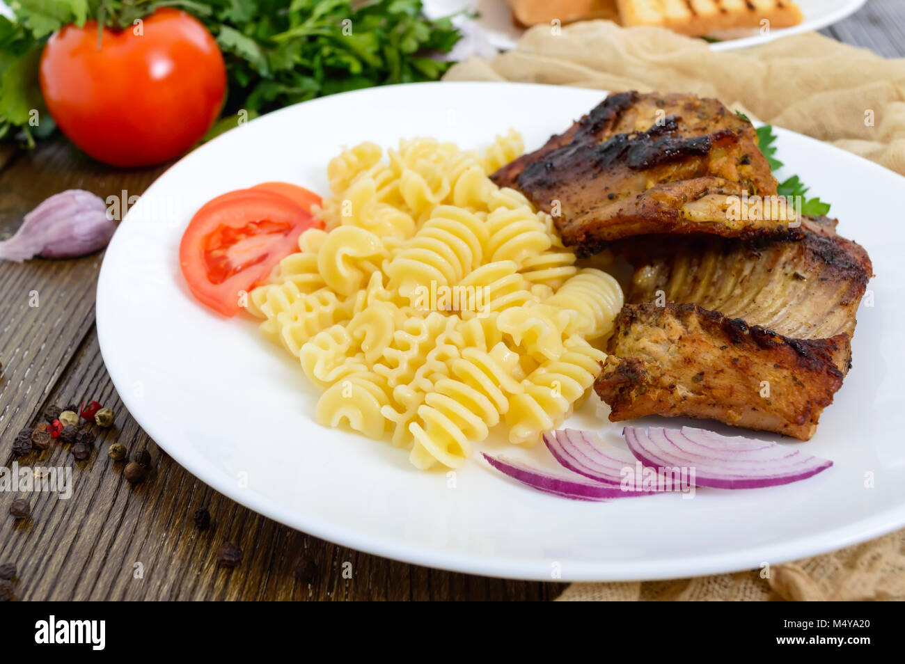Pasta Radiatori and fried rabbit ribs Stock Photo - Alamy