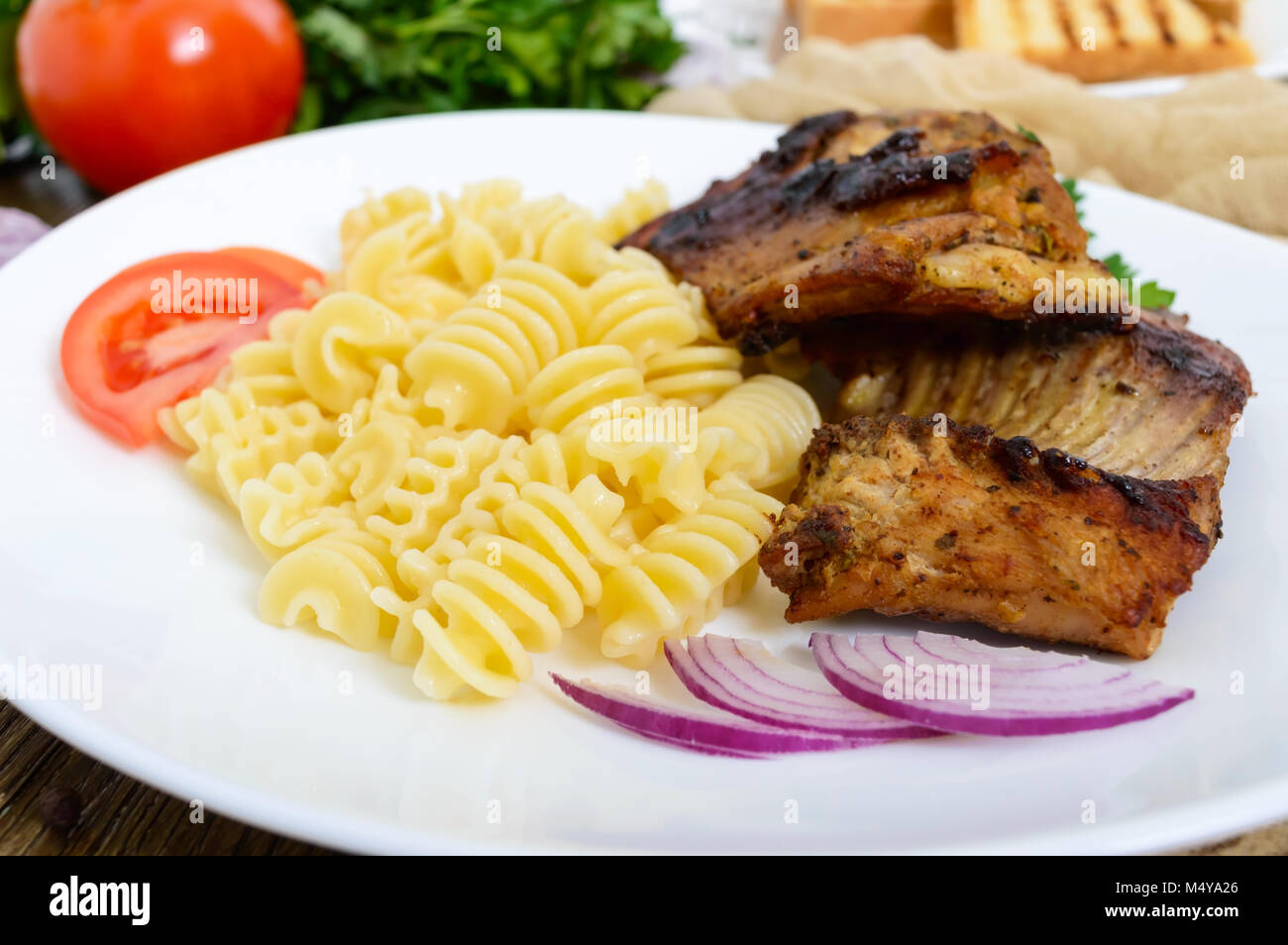 Pasta Radiatori and fried rabbit ribs Stock Photo - Alamy